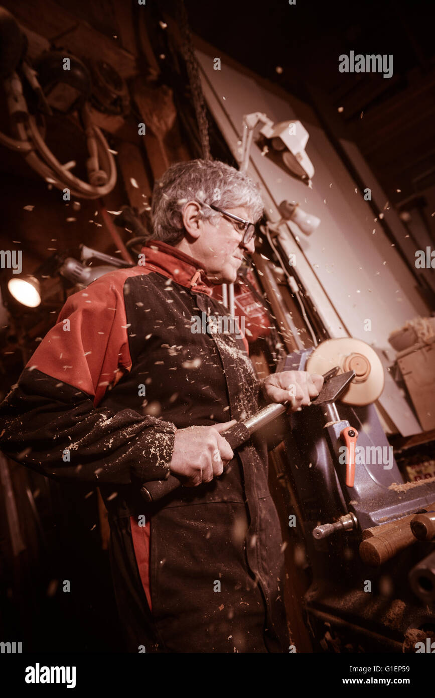 Wood turners using a rotating clamp to turn the wood, France Stock ...