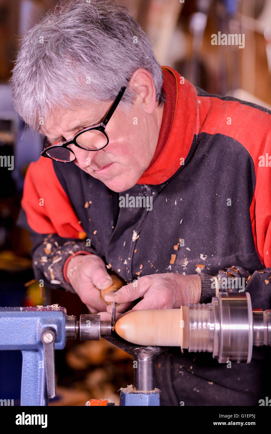 Wood turners using a rotating clamp to turn the wood, France Stock ...