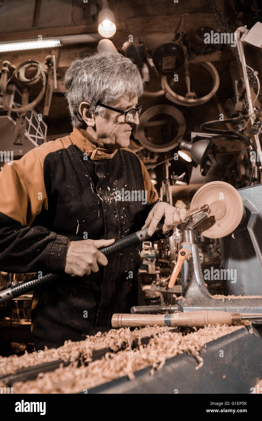Wood turners using a rotating clamp to turn the wood, France Stock ...