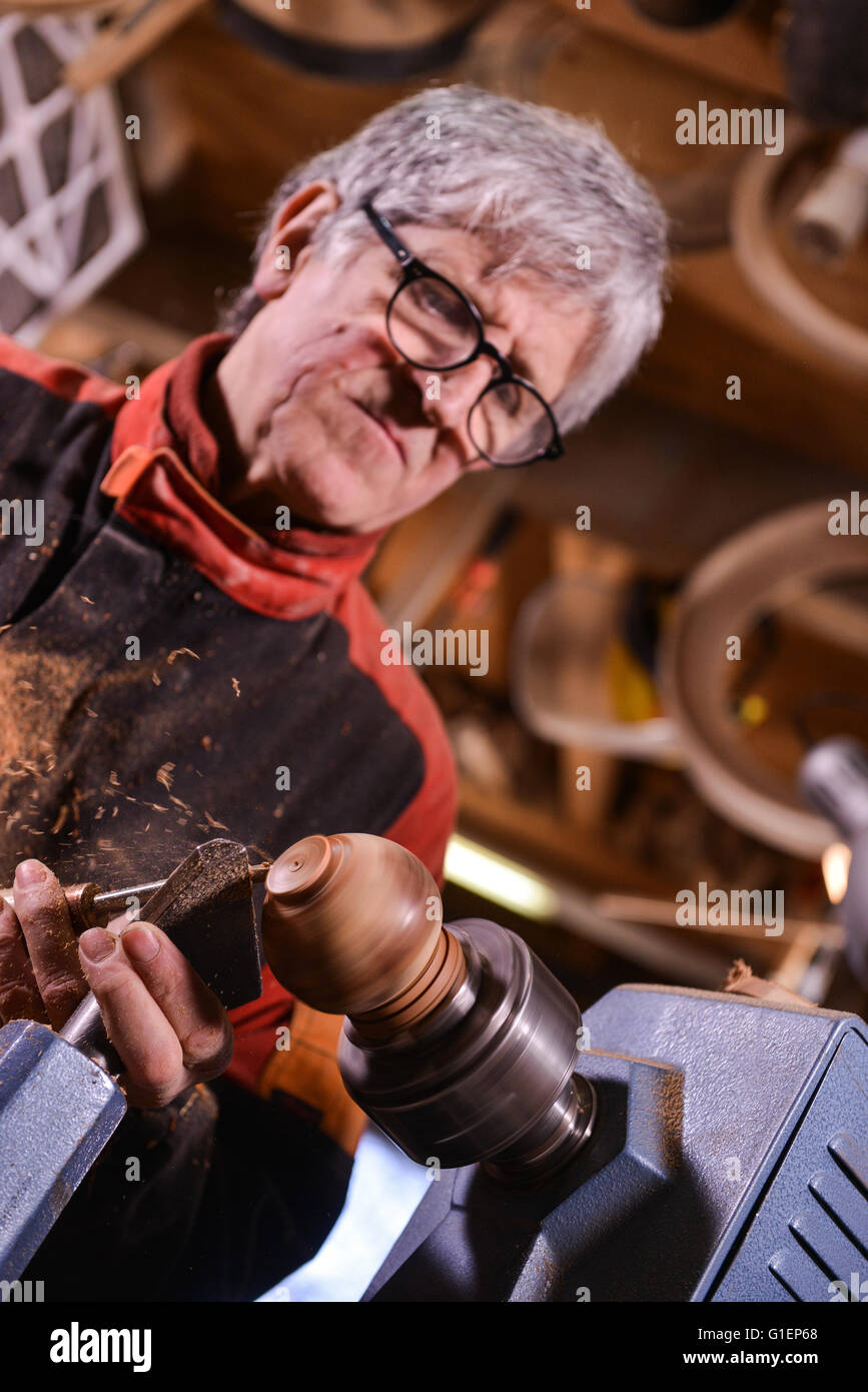 Wood turners using a rotating clamp to turn the wood, France Stock ...