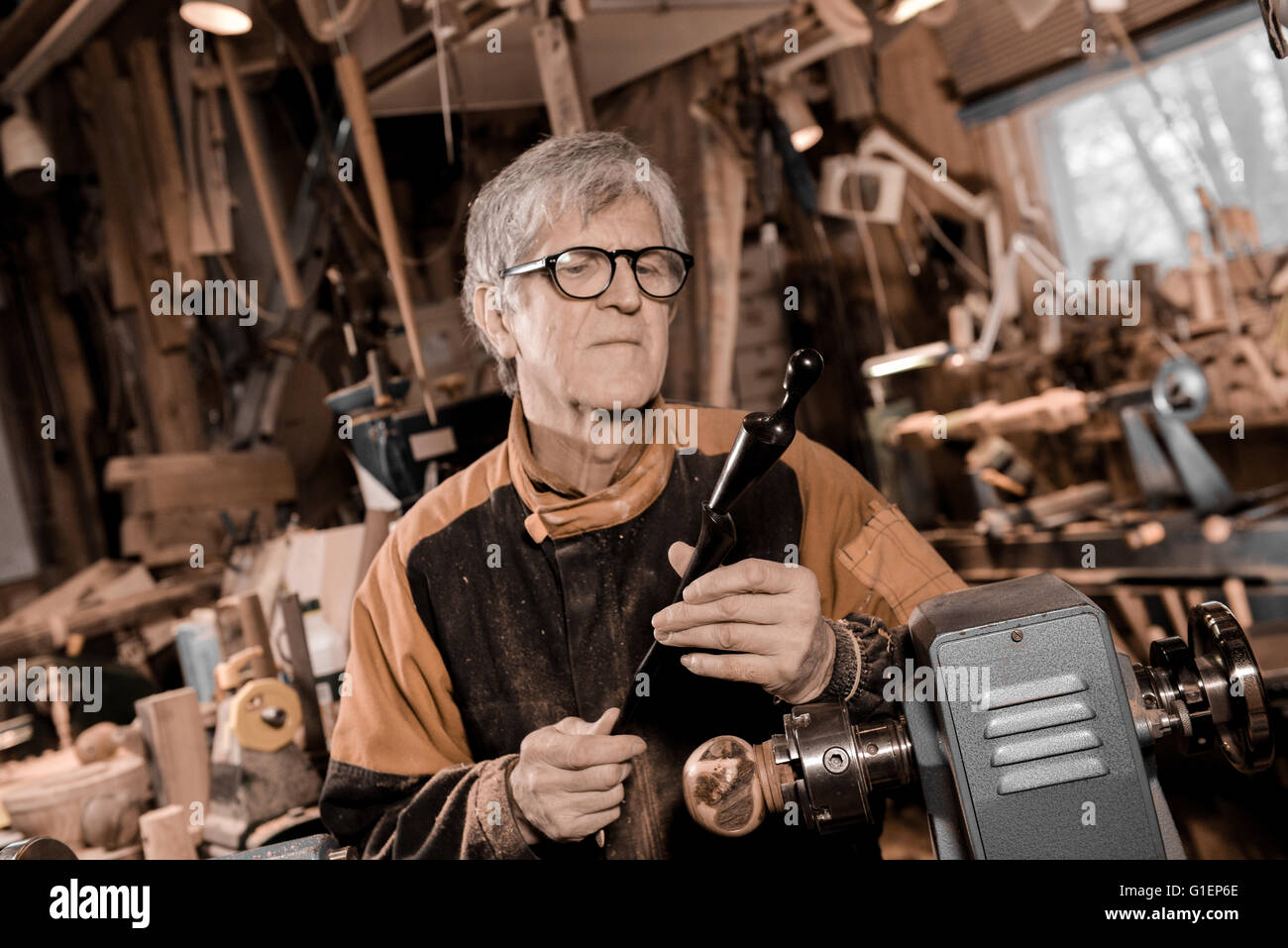 Wood turners using a rotating clamp to turn the wood, France Stock ...
