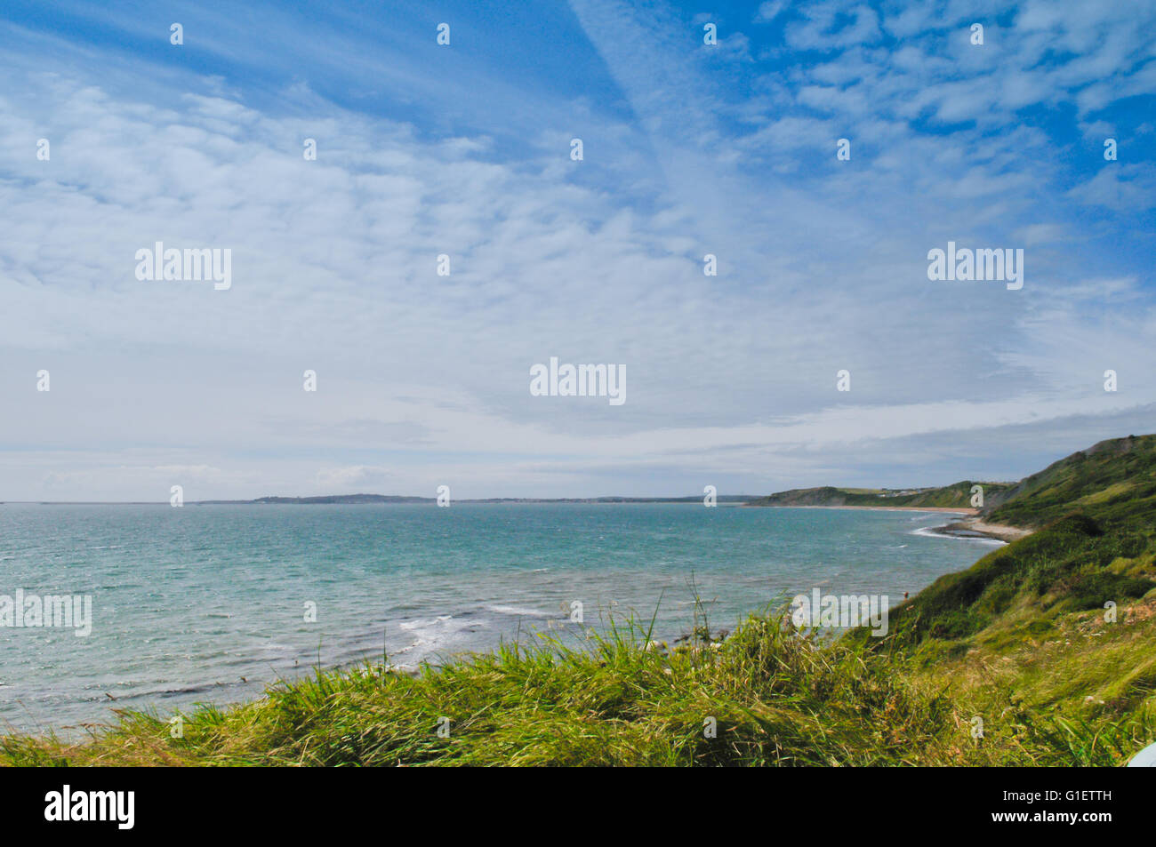 Sunny and windy view from a cliff with the blue ocean and coastline ...