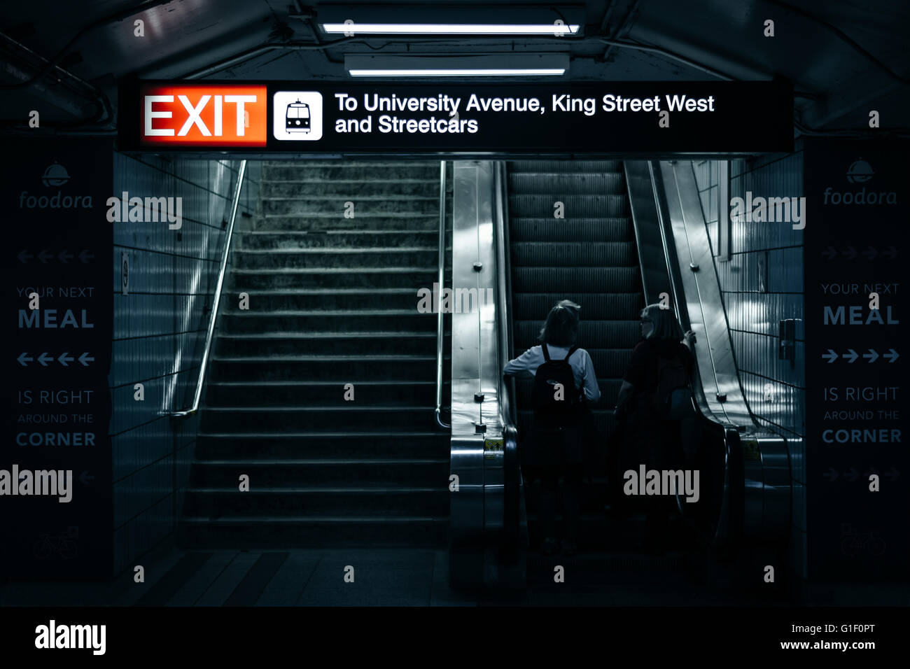 Stairs and signs in the St. Andrews Subway Station, in Toronto, Ontario ...