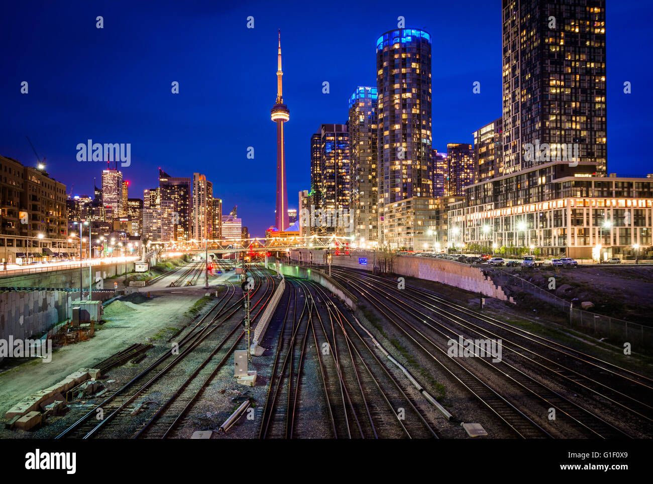 View of a rail yard and modern buildings in downtown at night, from the ...
