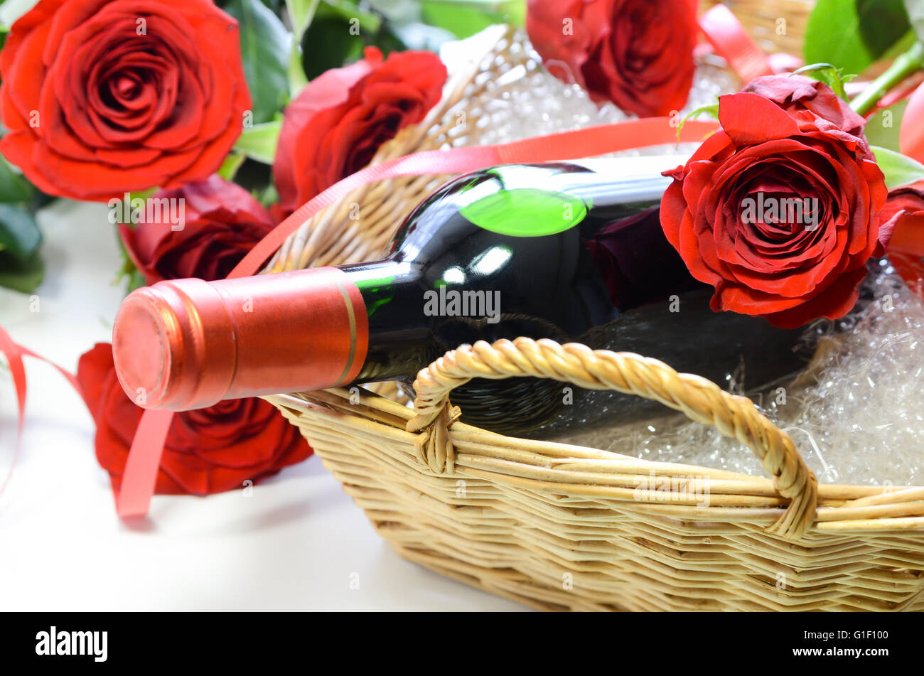 red wine bottles with red roses Stock Photo - Alamy