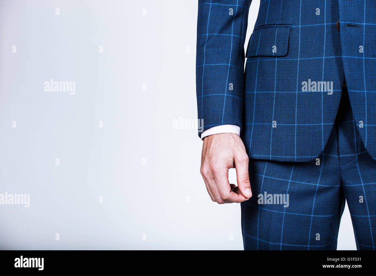 Detail of a businessman's hand with blue suit jacket Stock Photo - Alamy
