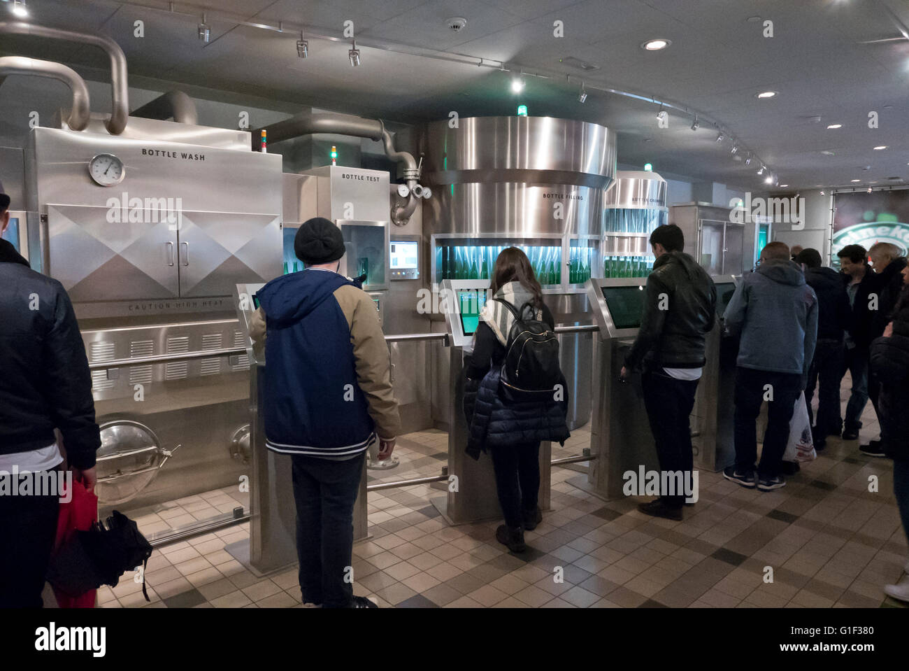 Visitors watching the Heineken brewing production line at the Heineken ...