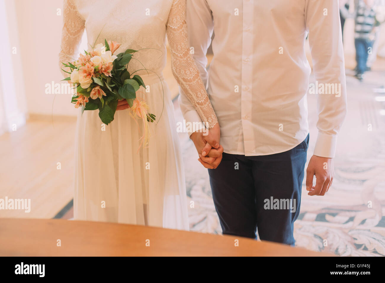 Bride and groom holding each other's hands with rings at wedding ...