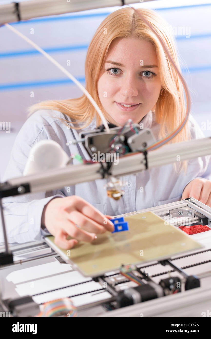 MODEL RELEASED. Female technician using a 3d printer Stock Photo - Alamy