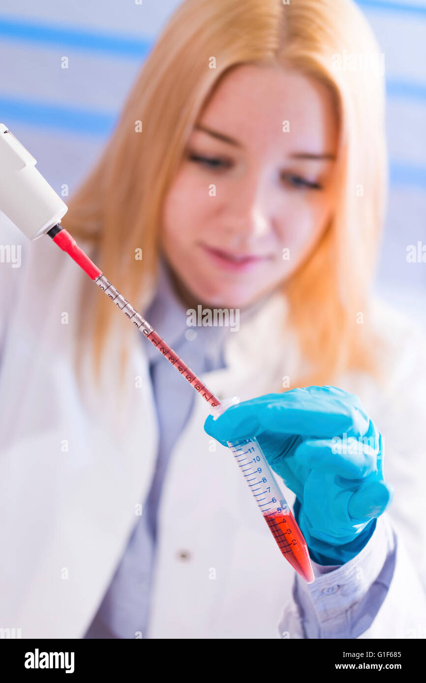 Person holding pipette with test tube hi-res stock photography and ...