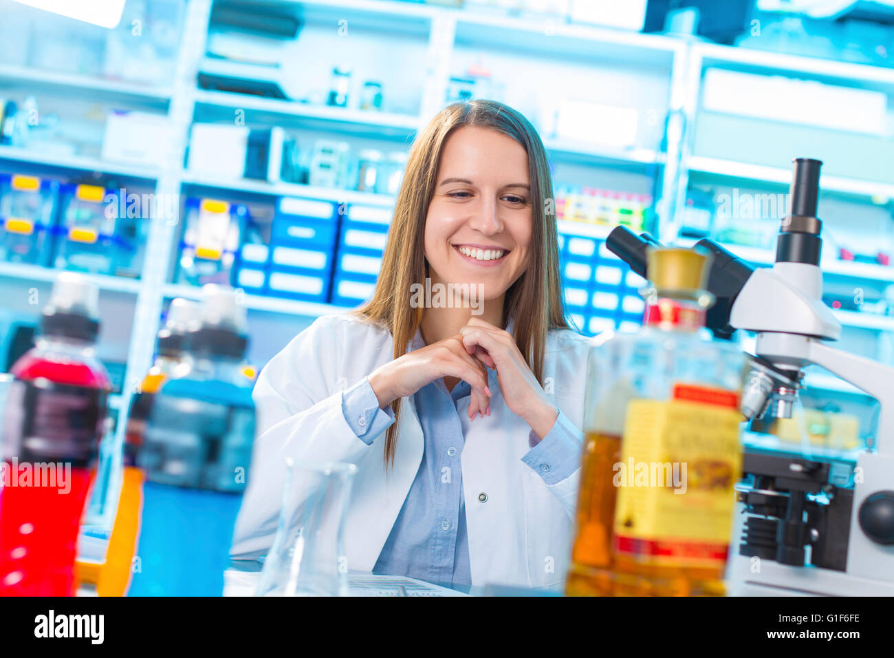 MODEL RELEASED. Female scientist in laboratory, smiling Stock Photo - Alamy