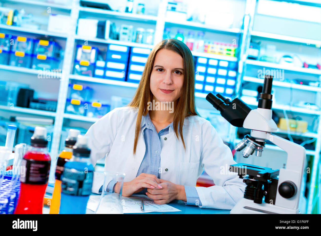 MODEL RELEASED. Female scientist in laboratory with microscope Stock ...