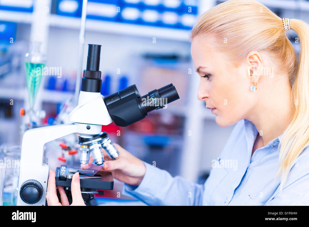 Model Released Female Scientist Using Microscope In The Laboratory