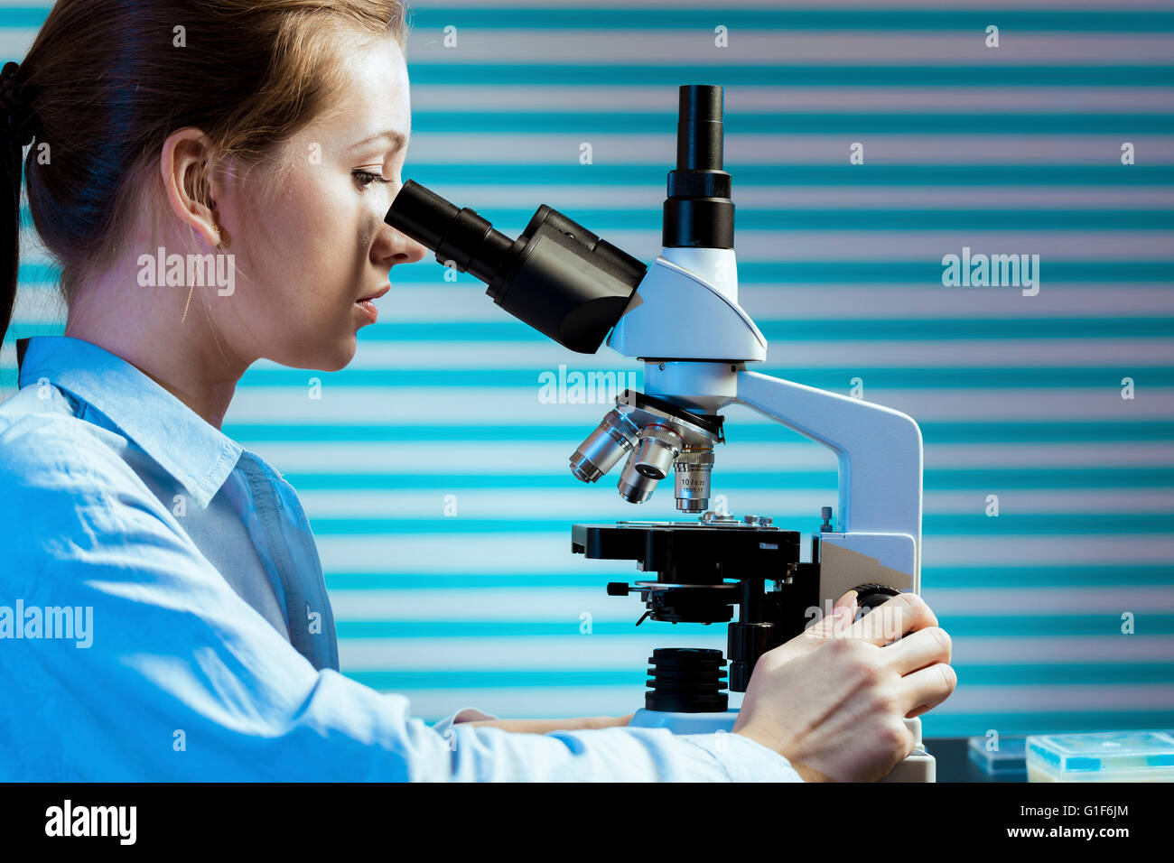 MODEL RELEASED. Female scientist using a microscope Stock Photo - Alamy