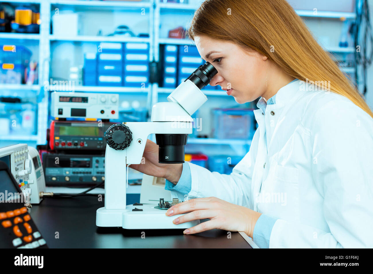 MODEL RELEASED. Female laboratory technician using a microscope Stock ...