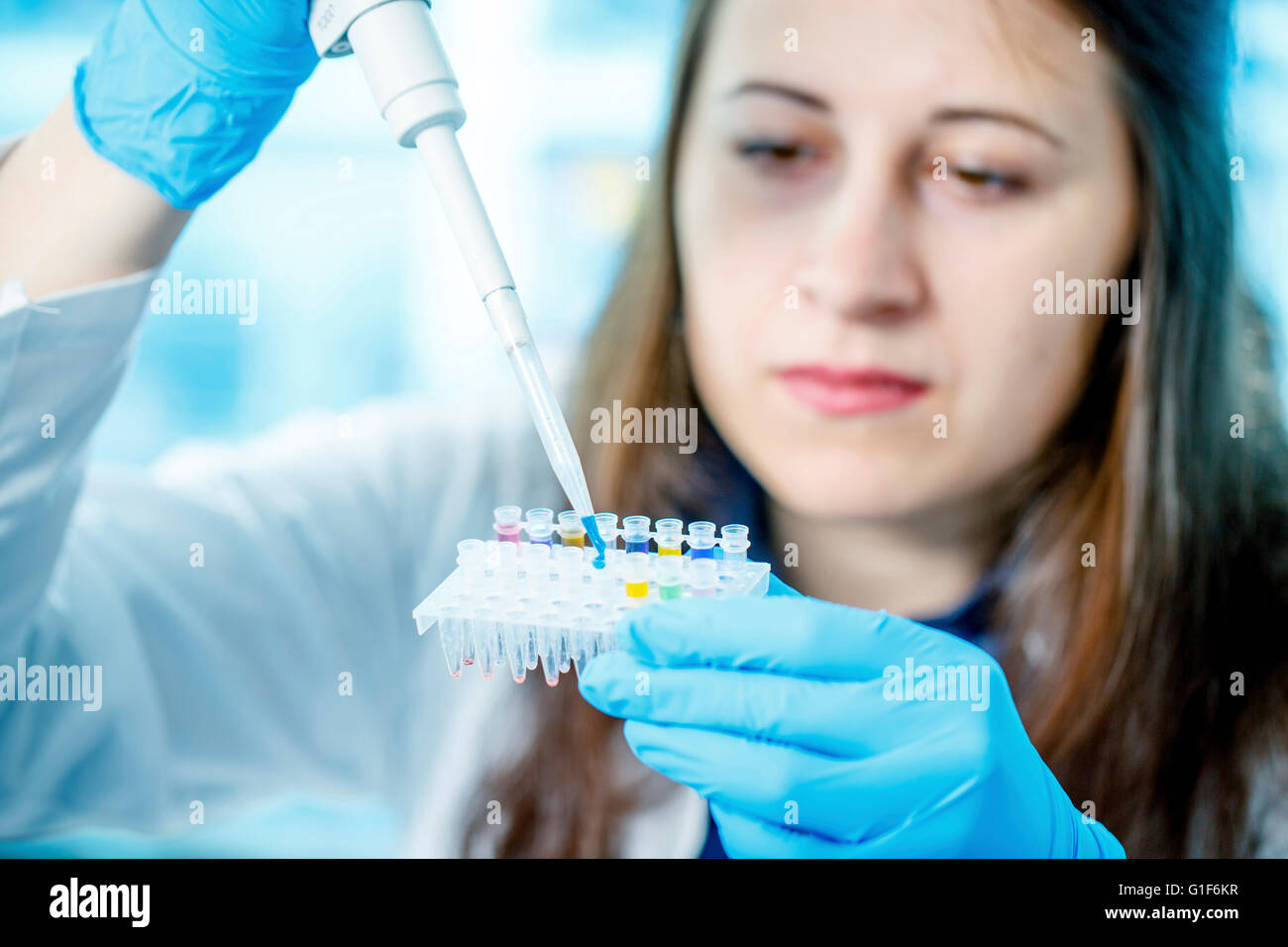 Woman holding tubes hi-res stock photography and images - Alamy