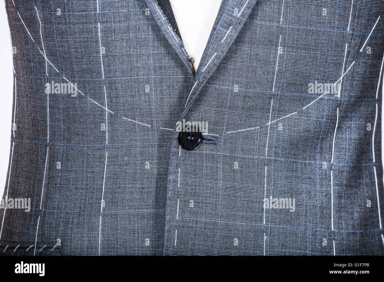 Details of a tailored suit jacket with markings on it for stitching ...