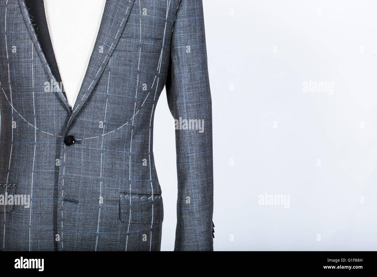 Details of a tailored suit jacket with markings on it for stitching ...