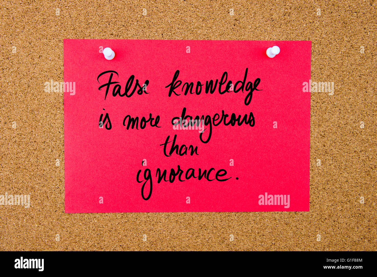 Red paper note with handwritten text False Knowledge Is More Dangerous ...