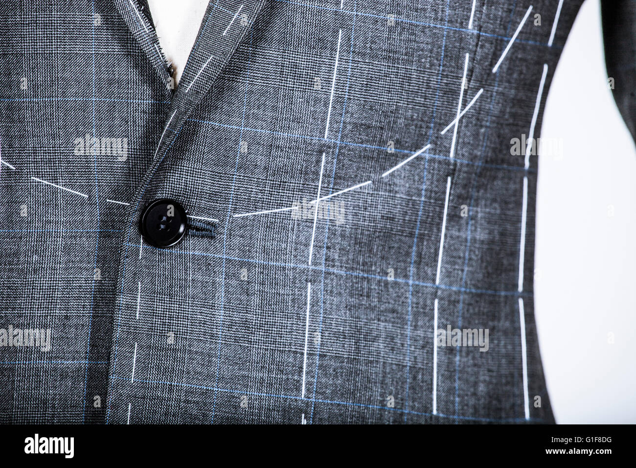 Details of a tailored suit jacket with markings on it for stitching ...