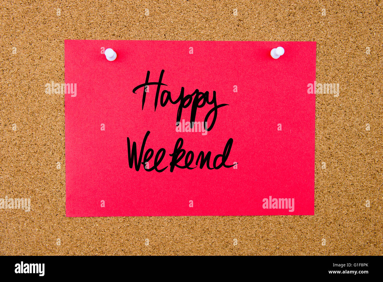 Red paper note with handwritten text Happy Weekend pinned on cork board ...