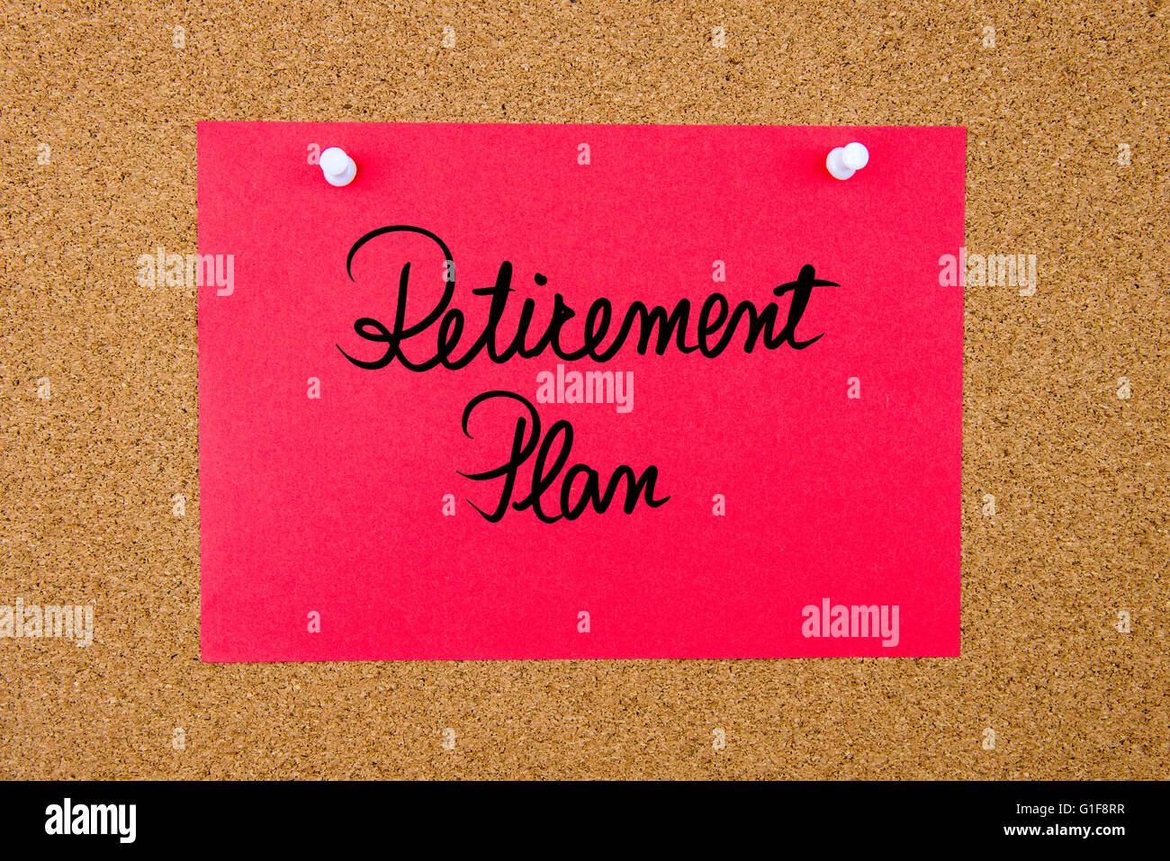 Red paper note with handwritten text Retirement Plan pinned on cork ...