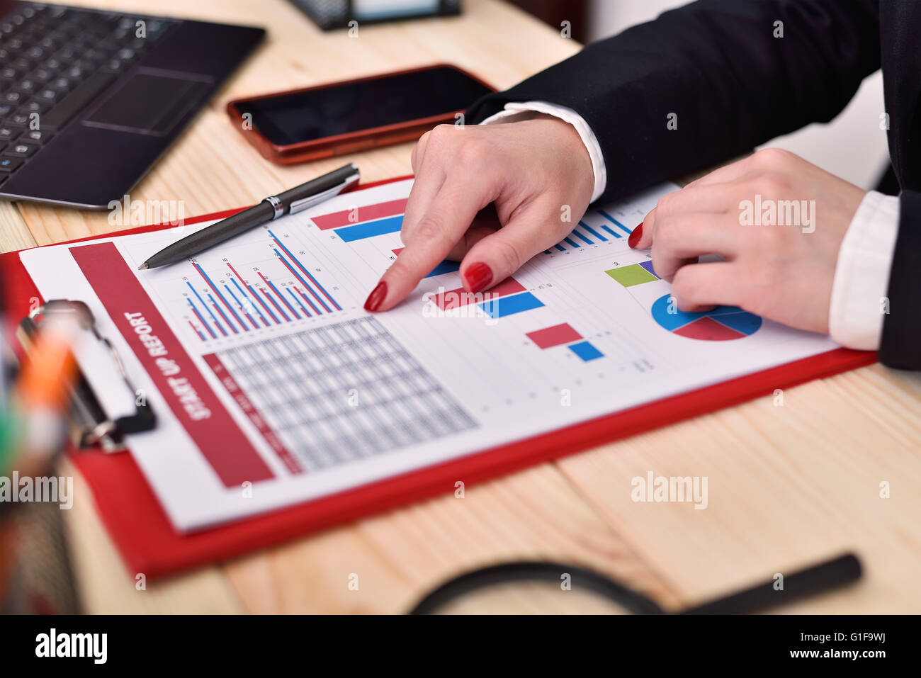 hand checks the start up report. business concept Stock Photo - Alamy