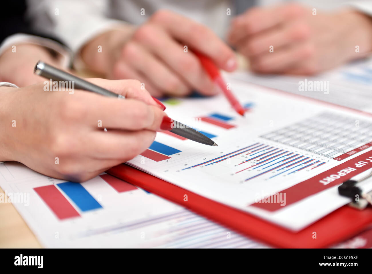 human hands analyzing the business diagrams on foreground Stock Photo ...