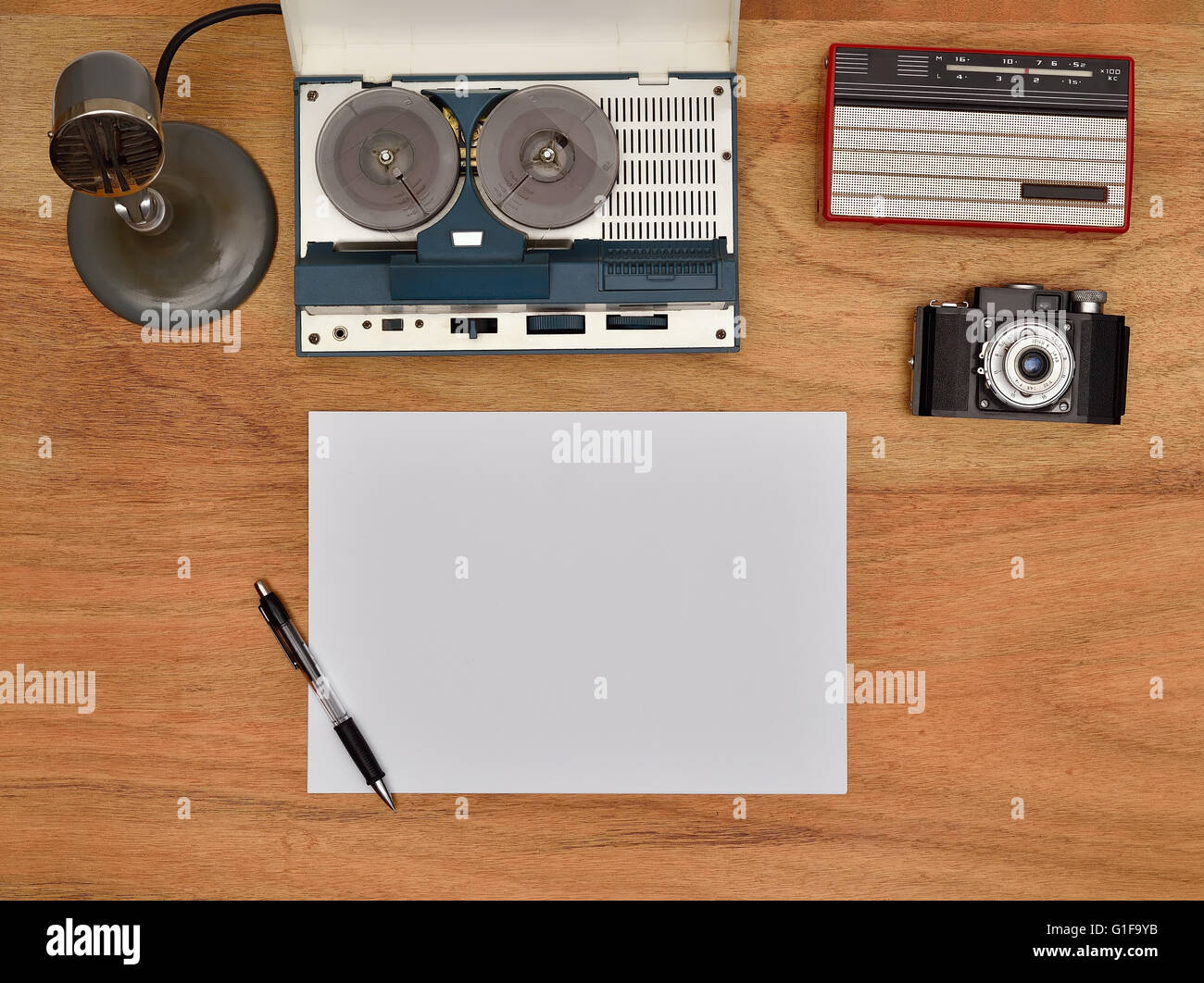 Old retro reel tape recorder, vintage radio, retro camera on wooden ...