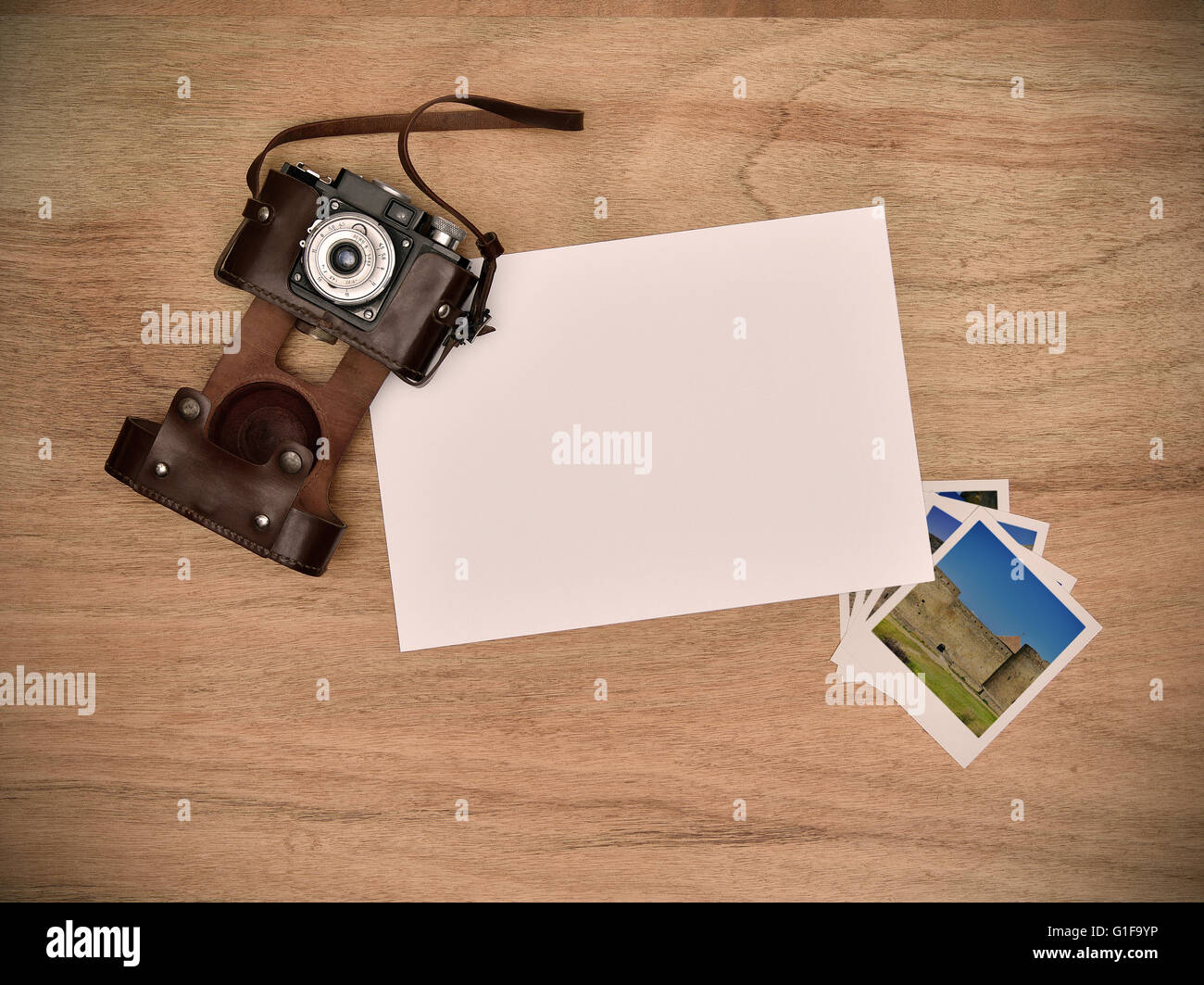 Work desk tourist. Camera, photo and blank paper on table Stock Photo ...