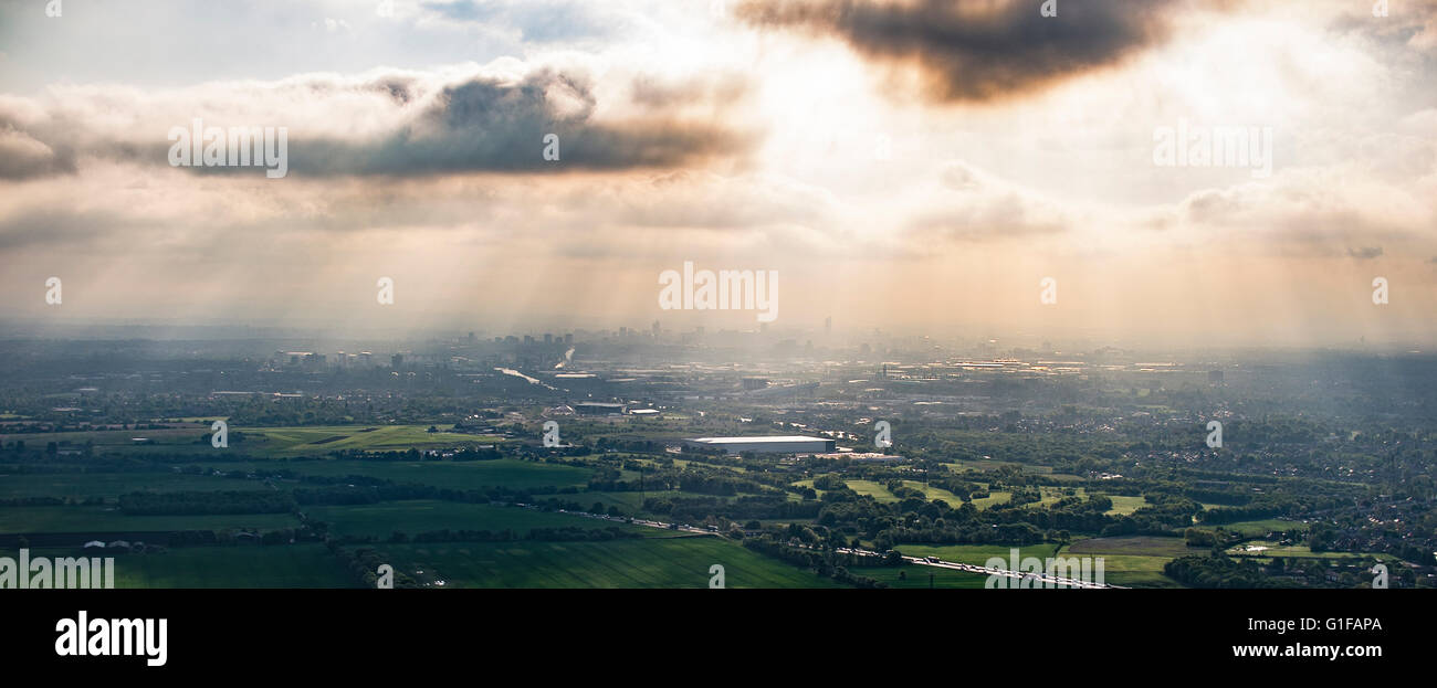 Aerial panoramic photo of Manchester below dramatic cloudy sky with sun ...