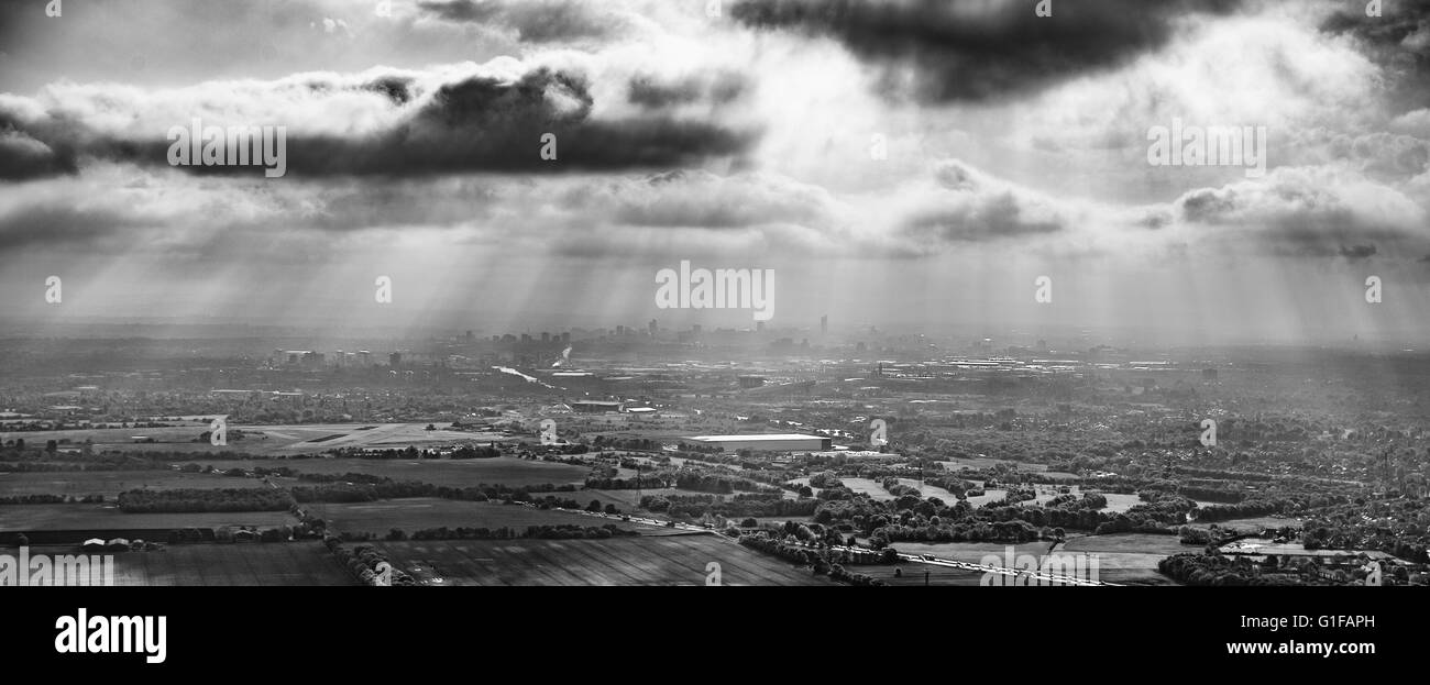 Aerial panoramic photo of Manchester below dramatic cloudy sky with sun ...