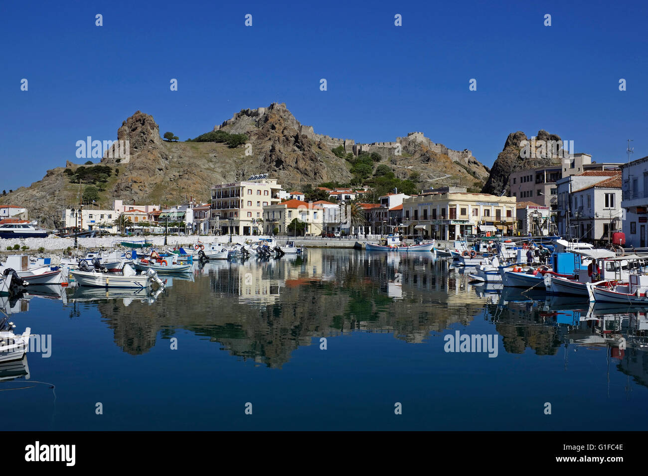 Lemnos island promenade harbor and Myrina's historical castle reflected ...