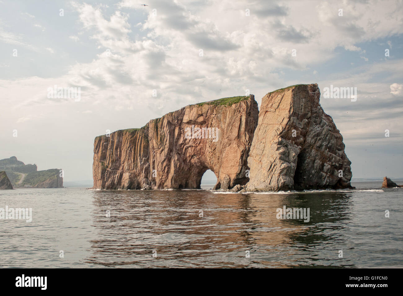 Rocher Percé is a massive rock formation emerging out of the Gulf of St ...