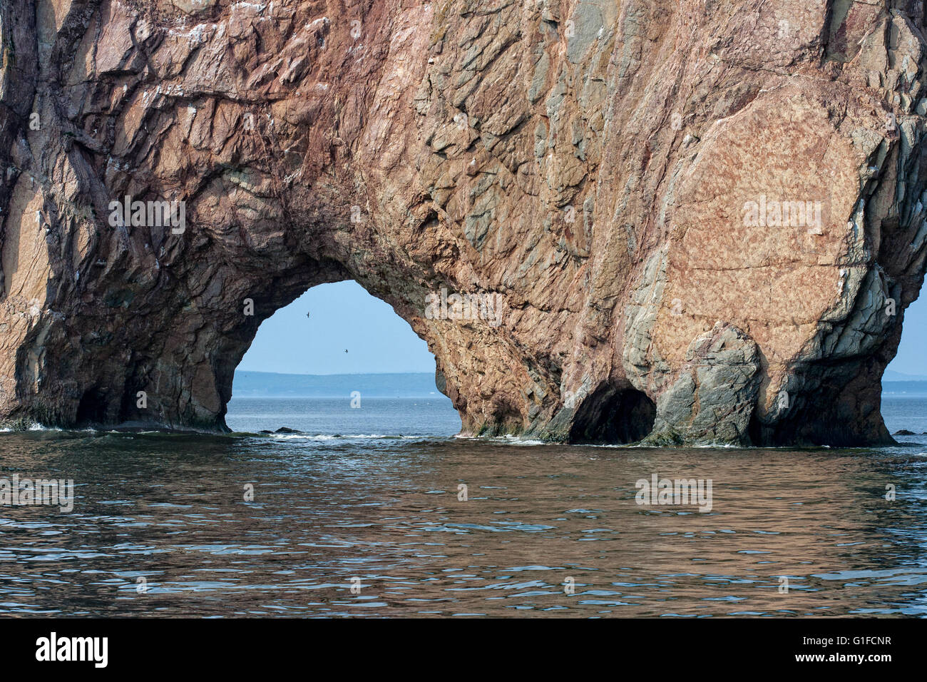 Rocher Percé is a massive rock formation emerging out of the Gulf of St ...