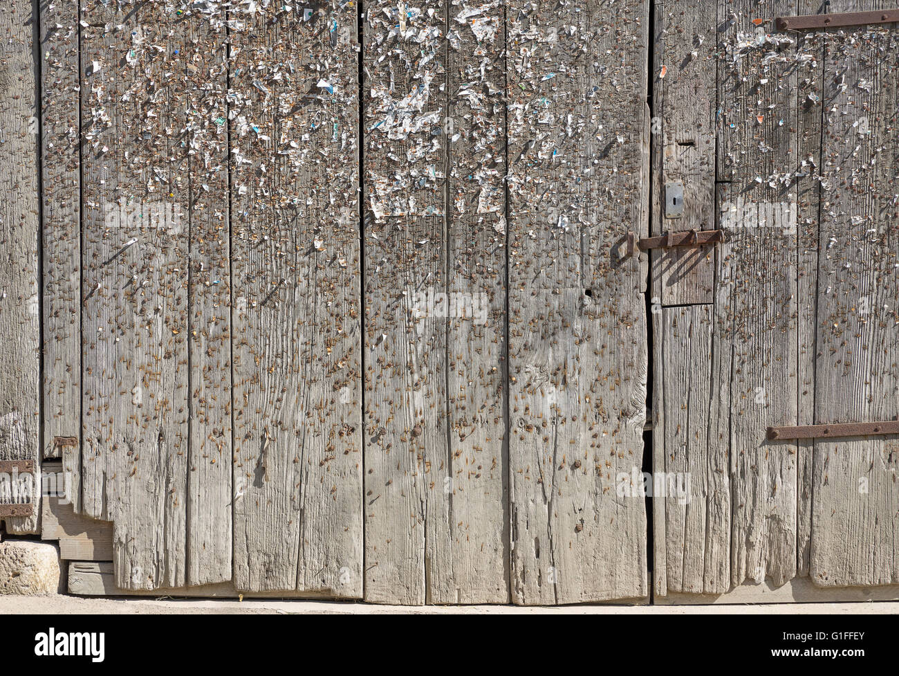 old weathered wooden gate blotched with lots of staples and pins Stock ...
