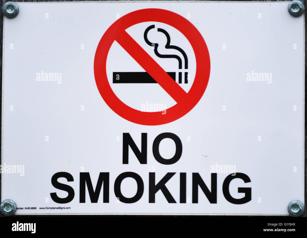 A standard no smoking sign held up with bolts Stock Photo - Alamy