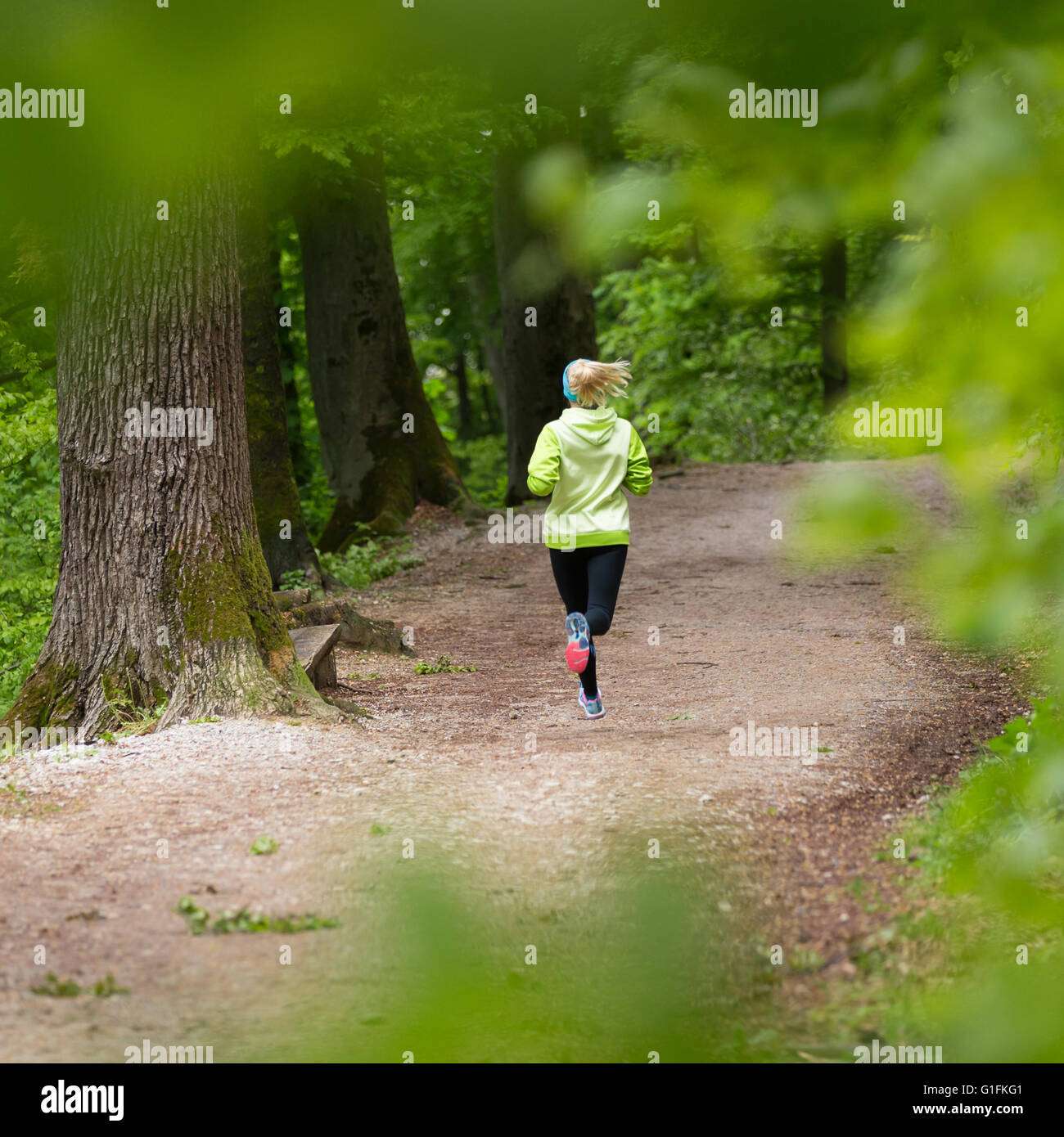 Sporty young female runner in the forest Stock Photo - Alamy
