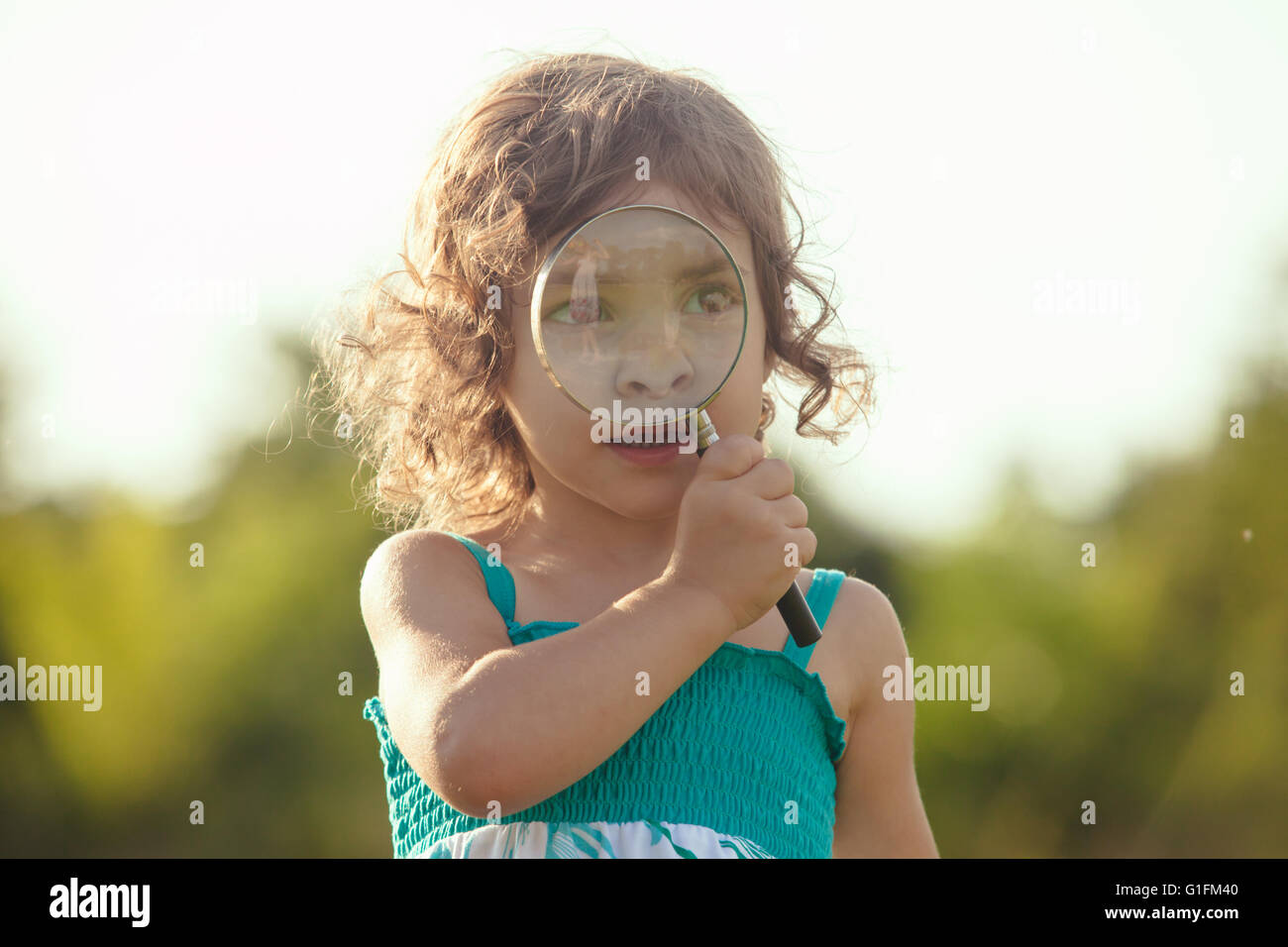 Kid with magnifying glass Stock Photo - Alamy
