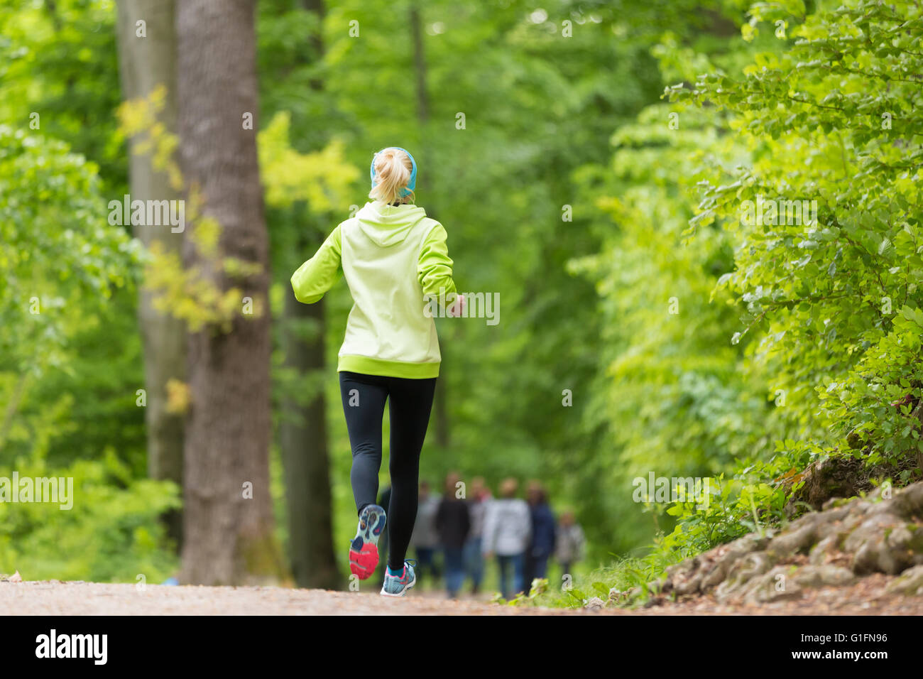Sporty young female runner in the forest Stock Photo - Alamy