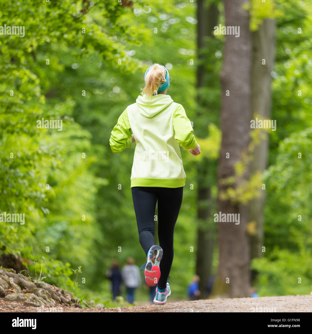 Sporty young female runner in the forest Stock Photo - Alamy