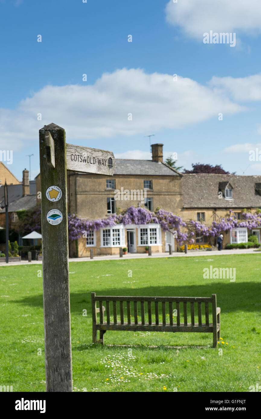 Cotswold way signpost in front of Wisteria covered shop. Broadway ...
