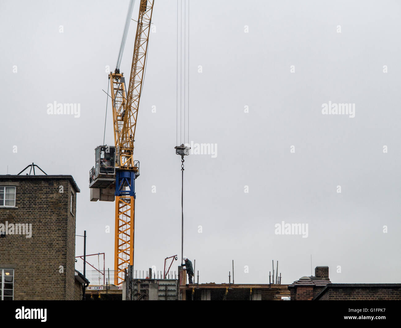 Crane lifting building materials on hi-res stock photography and images ...