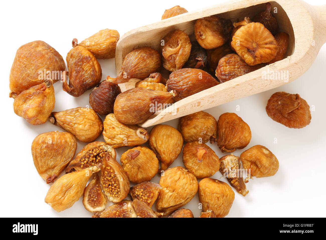 scoop of sun dried figs on white background Stock Photo - Alamy