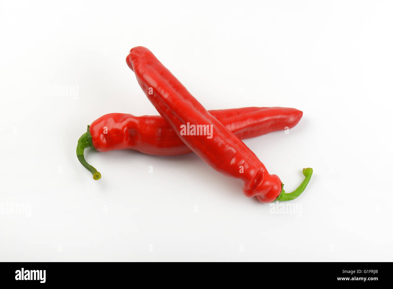 two red peppers on white background Stock Photo - Alamy