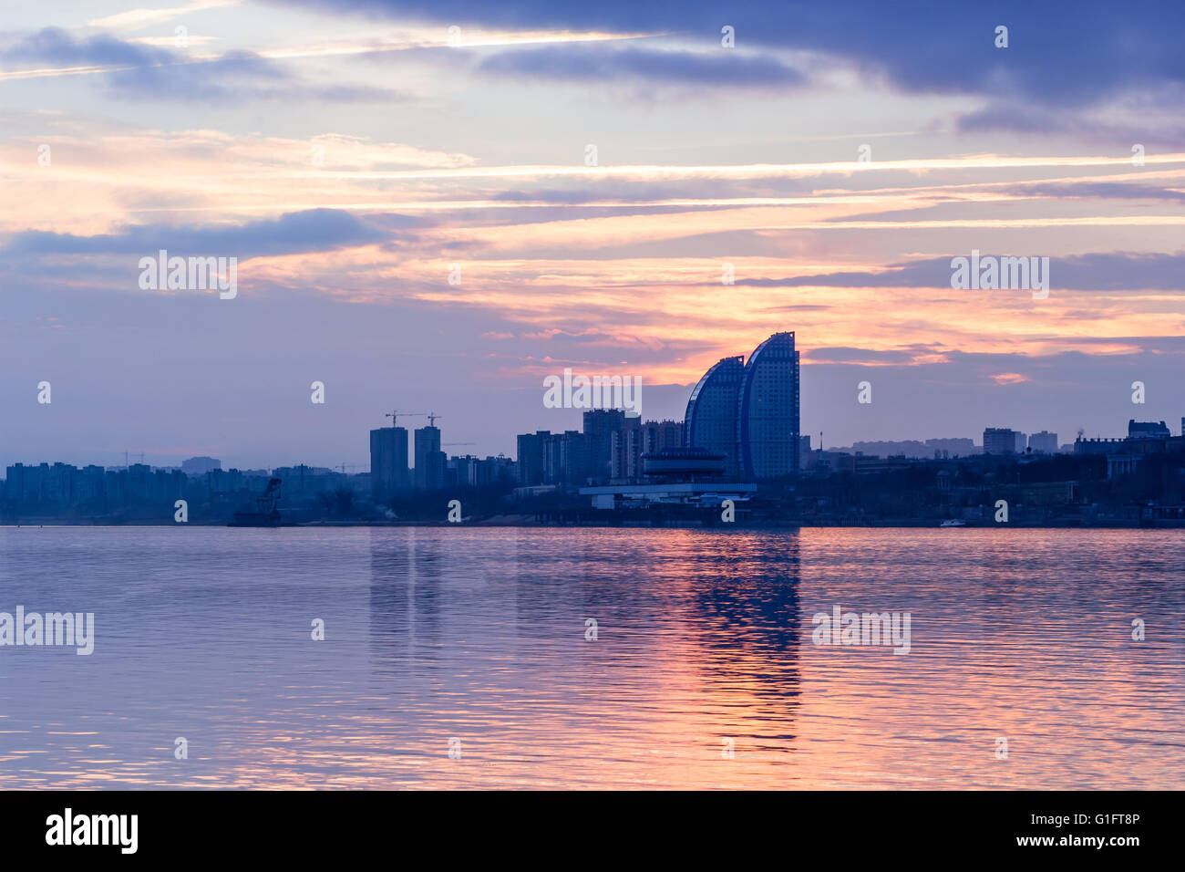 Reflection of urban architecture in the river at sunset Stock Photo - Alamy