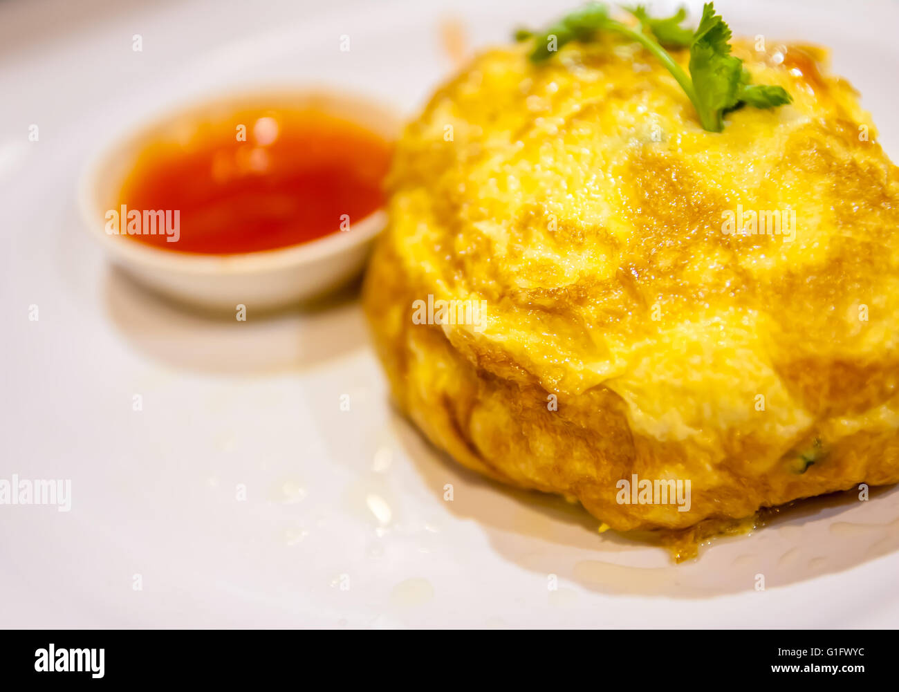 Big omelette with spicy sauce on white dish Stock Photo - Alamy