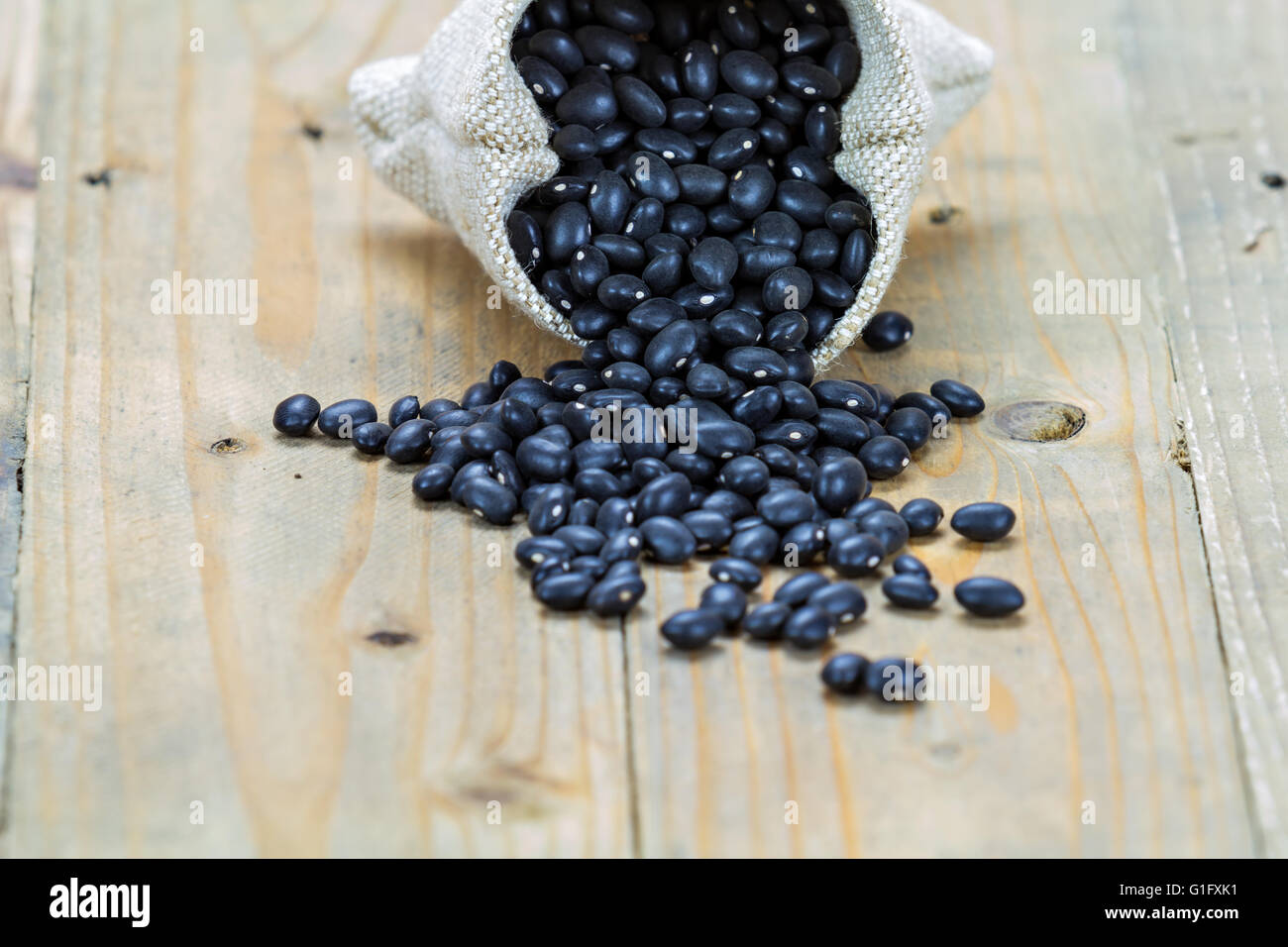 Black beans in sack on vintage wooden boards Stock Photo - Alamy