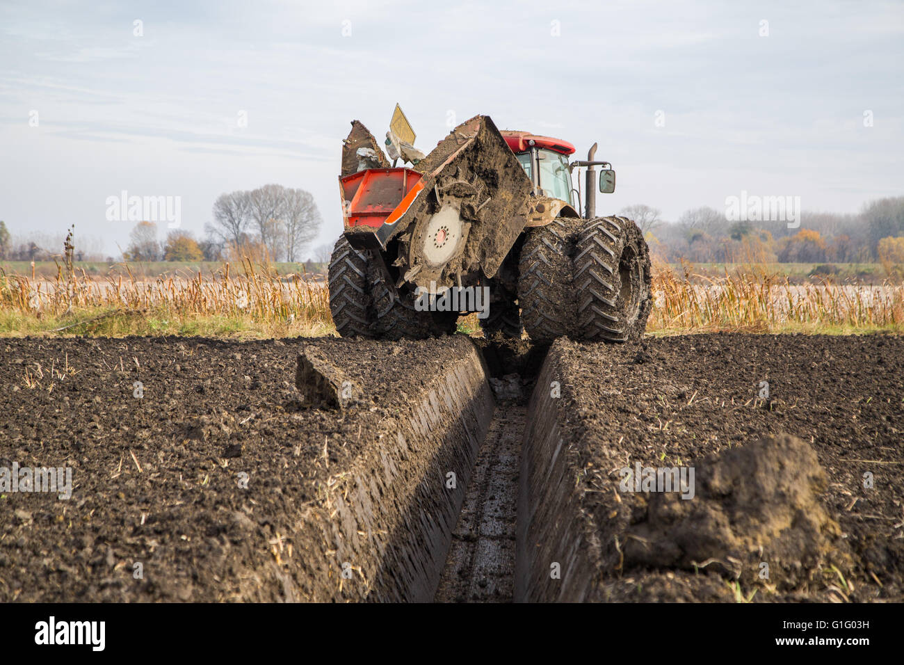 Tractor with double wheeled ditcher digging drainage canal Stock Photo ...