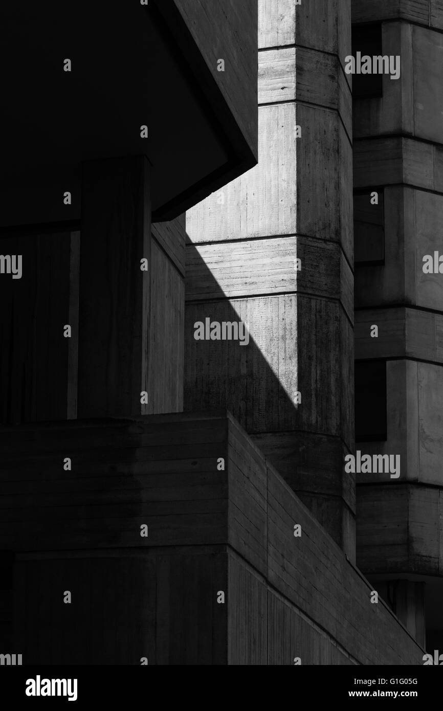 Concrete buildings in shadow with sun spot on wall, arrow shape Stock ...
